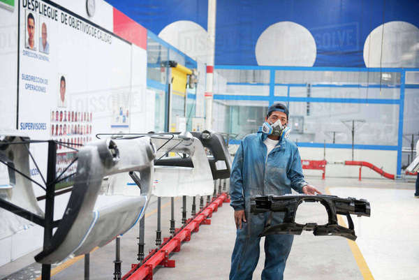 Worker holding machinery in manufacturing plant - Royalty-free Stock ...