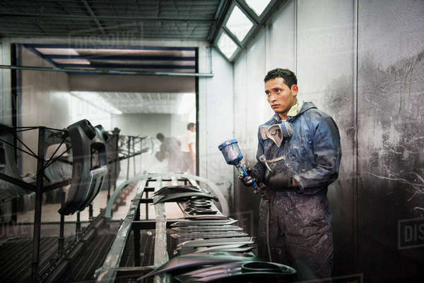 Worker spray painting in manufacturing plant - Royalty-free Stock Photo ...