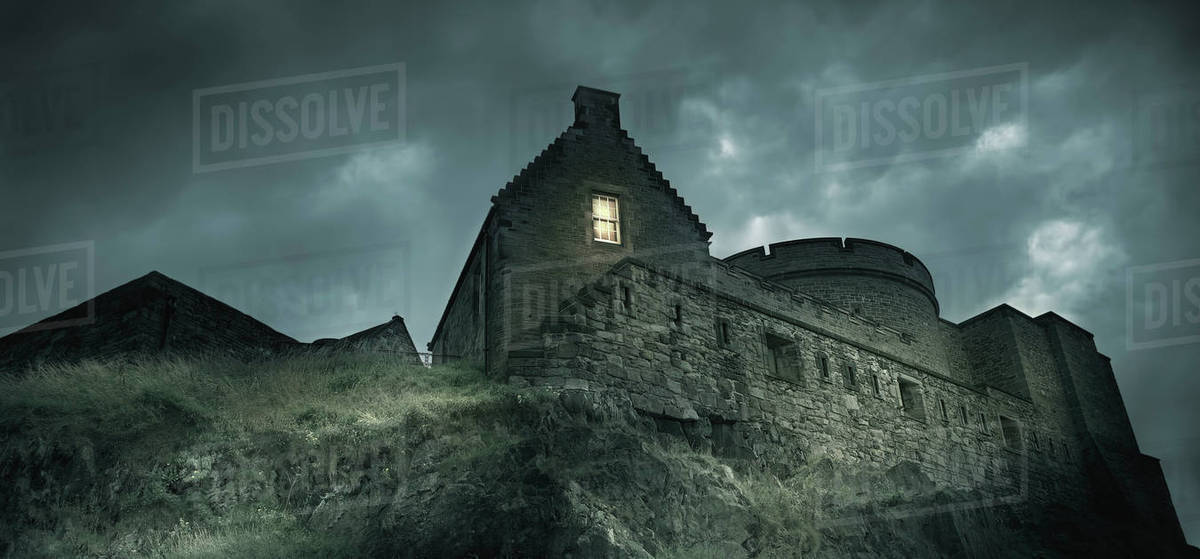 Low angle view of castle on rocky hill - Stock Photo - Dissolve