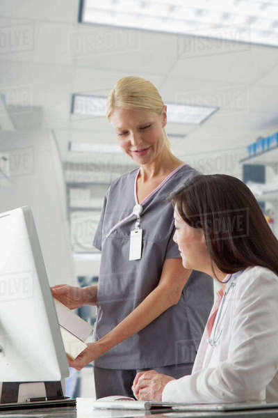 Doctor and nurse working at computer in hospital - Royalty-free Stock ...