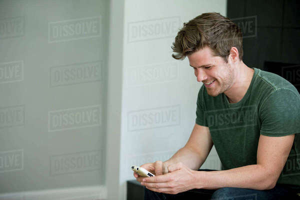 Man using cell phone - Stock Photo - Dissolve