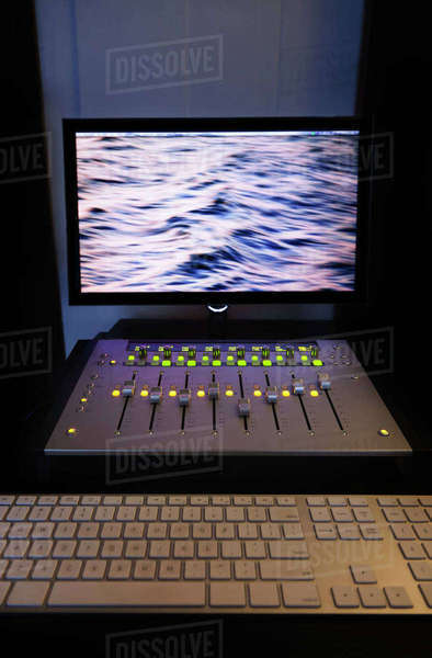 A computer workstation with sound board in a home recording studio ...