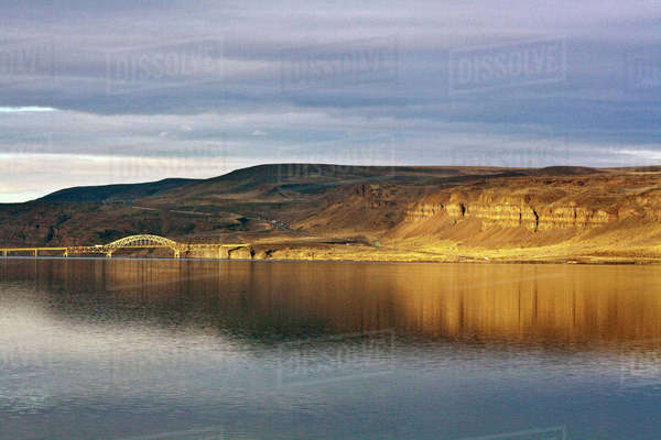 Barren Cliff Face Reflected in Water - Royalty-free Stock Photo | Dissolve