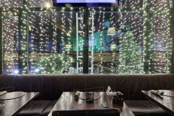 Illuminated restaurant window - Stock Photo - Dissolve