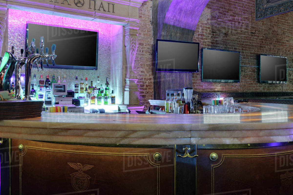 TV screens in a row against bar stand - Royalty-free Stock Photo | Dissolve