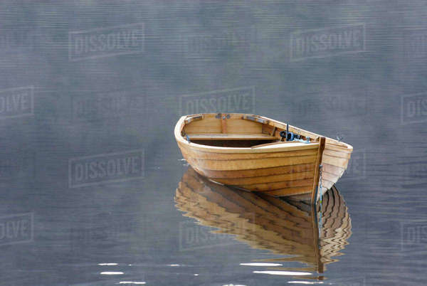 A single wooden rowing boat - Royalty-free Stock Photo | Dissolve
