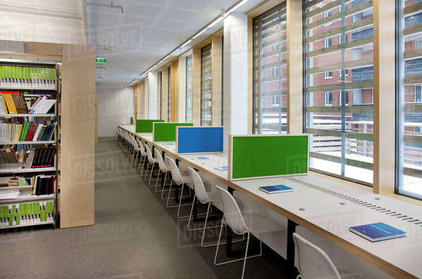 Books on tables in library - Royalty-free Stock Photo | Dissolve