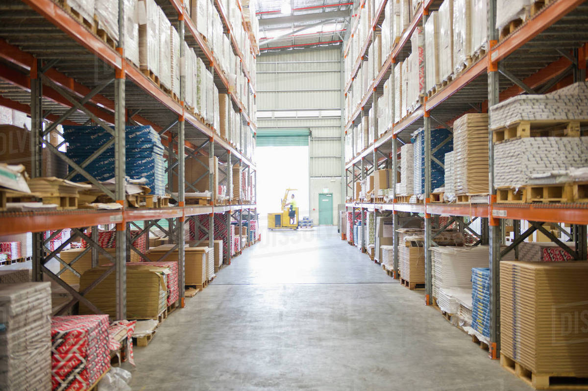Products stacked on warehouse shelves - Royalty-free Stock Photo | Dissolve