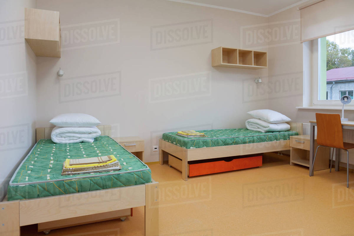 A dormitory bedroom with beds and bed linen - Royalty-free Stock Photo ...