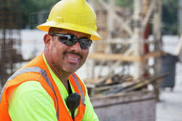 Hispanic worker smiling at construction site - Royalty-free Stock Photo ...