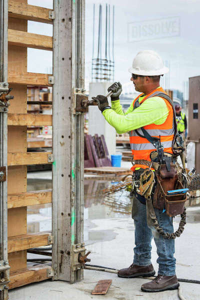 Hispanic worker at construction site - Stock Photo - Dissolve