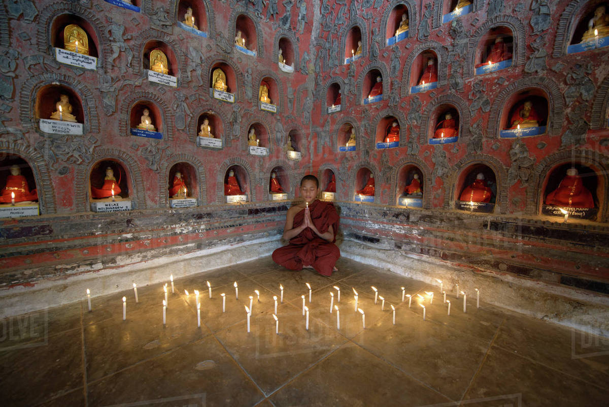 Asian monk-in-training praying in ancient temple - Royalty-free Stock ...