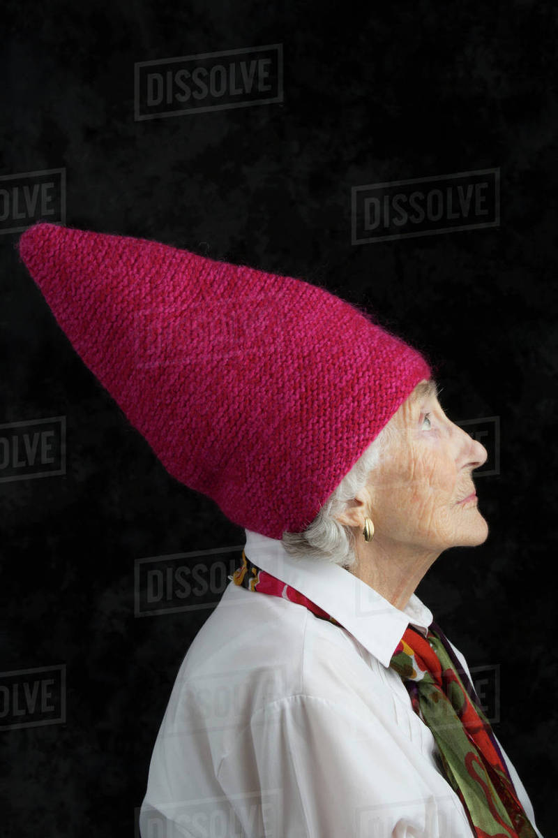 Close up of older woman wearing dunce cap - Stock Photo - Dissolve