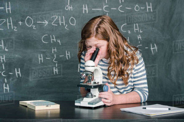Caucasian student using microscope in science class - Stock Photo ...