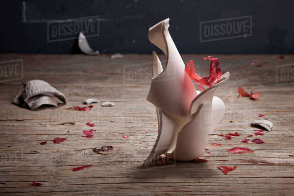 Broken pottery vase on wooden table - Stock Photo - Dissolve