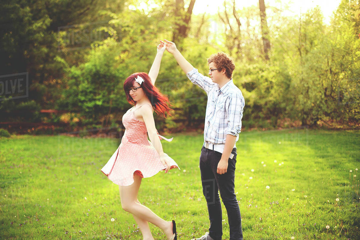 Couple dancing in grass - Stock Photo - Dissolve