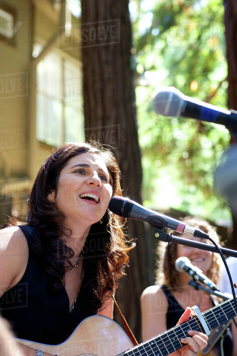 Musicians performing on stage outdoors - Stock Photo - Dissolve