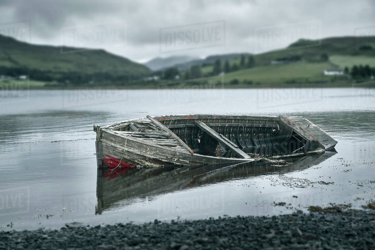 Dilapidated boat in rural lake - Royalty-free Stock Photo | Dissolve