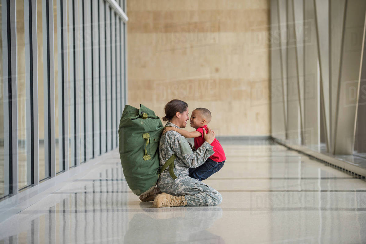 African American soldier hugging son in airport - Royalty-free Stock ...