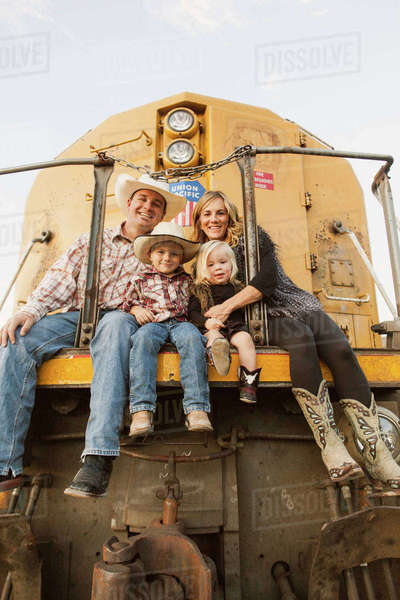 Family sitting on vintage train - Stock Photo - Dissolve