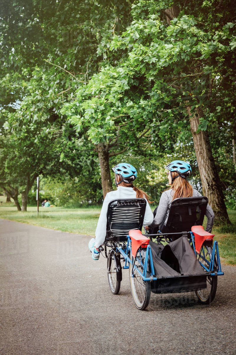 Caucasian mother and daughter riding tandem bicycle - Royalty-free ...
