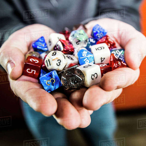 Hands holding variety of dice - Royalty-free Stock Photo | Dissolve