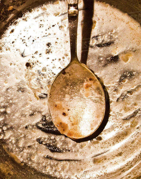Spoon in dirty pan - Stock Photo - Dissolve