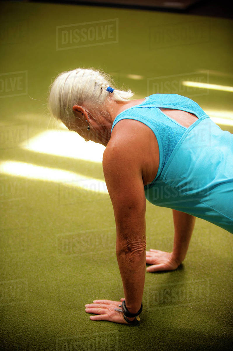 Older woman doing push-up - Royalty-free Stock Photo | Dissolve