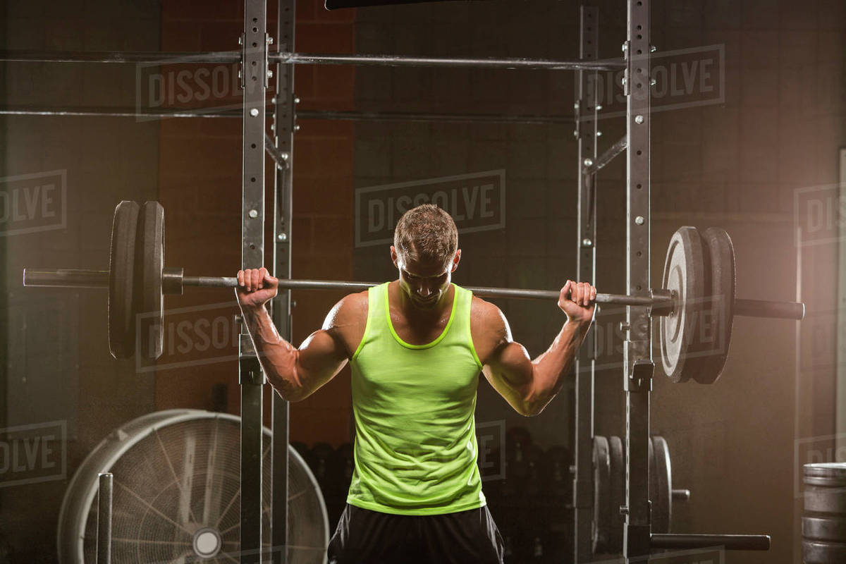 Caucasian man lifting barbell in gymnasium - Royalty-free Stock Photo ...
