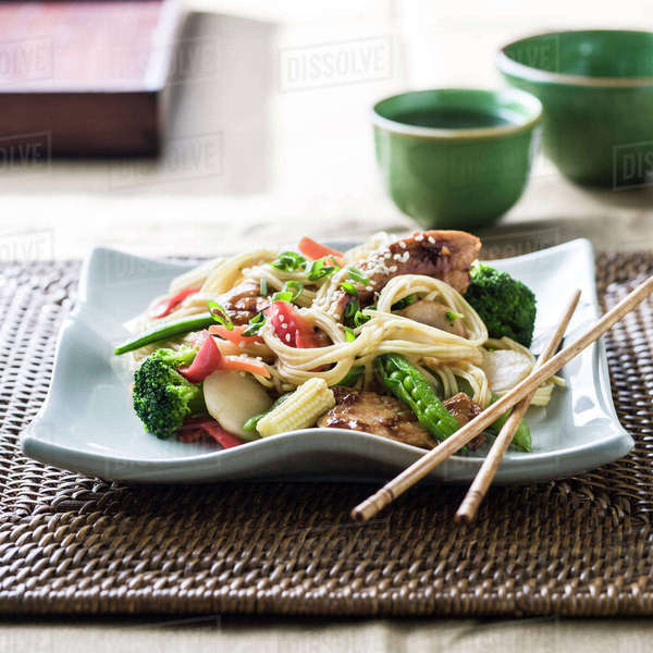 Stir fry on plate with chopsticks - Stock Photo - Dissolve