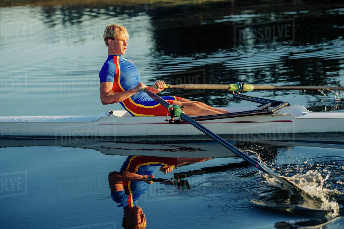 Caucasian man rowing on river - Royalty-free Stock Photo | Dissolve