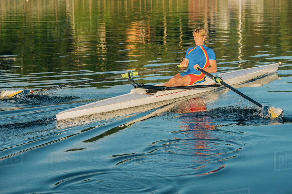 Caucasian man rowing on river - Stock Photo - Dissolve