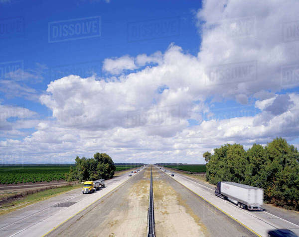 Cars and semi-trucks driving on freeway - Royalty-free Stock Photo ...