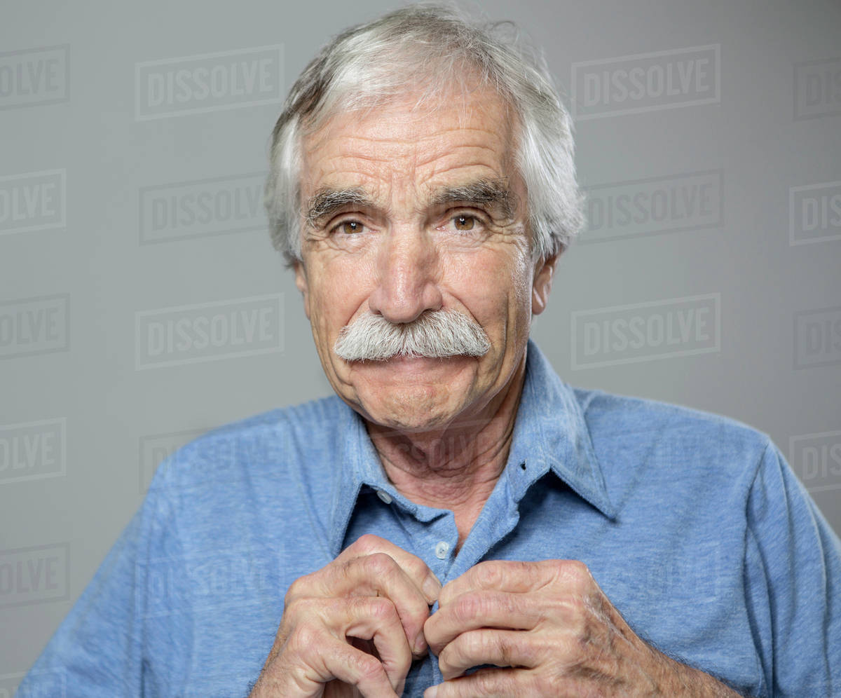 Close up of older Caucasian man buttoning his shirt - Royalty-free ...