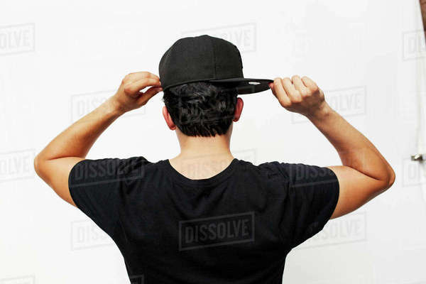 Rear view of man adjusting baseball cap - Royalty-free Stock Photo ...