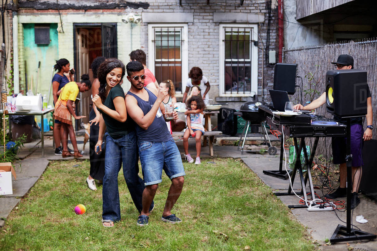 Couple dancing at backyard party - Royalty-free Stock Photo | Dissolve
