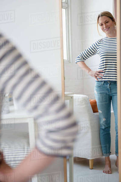 Reflection of standing woman in mirror - Royalty-free Stock Photo ...