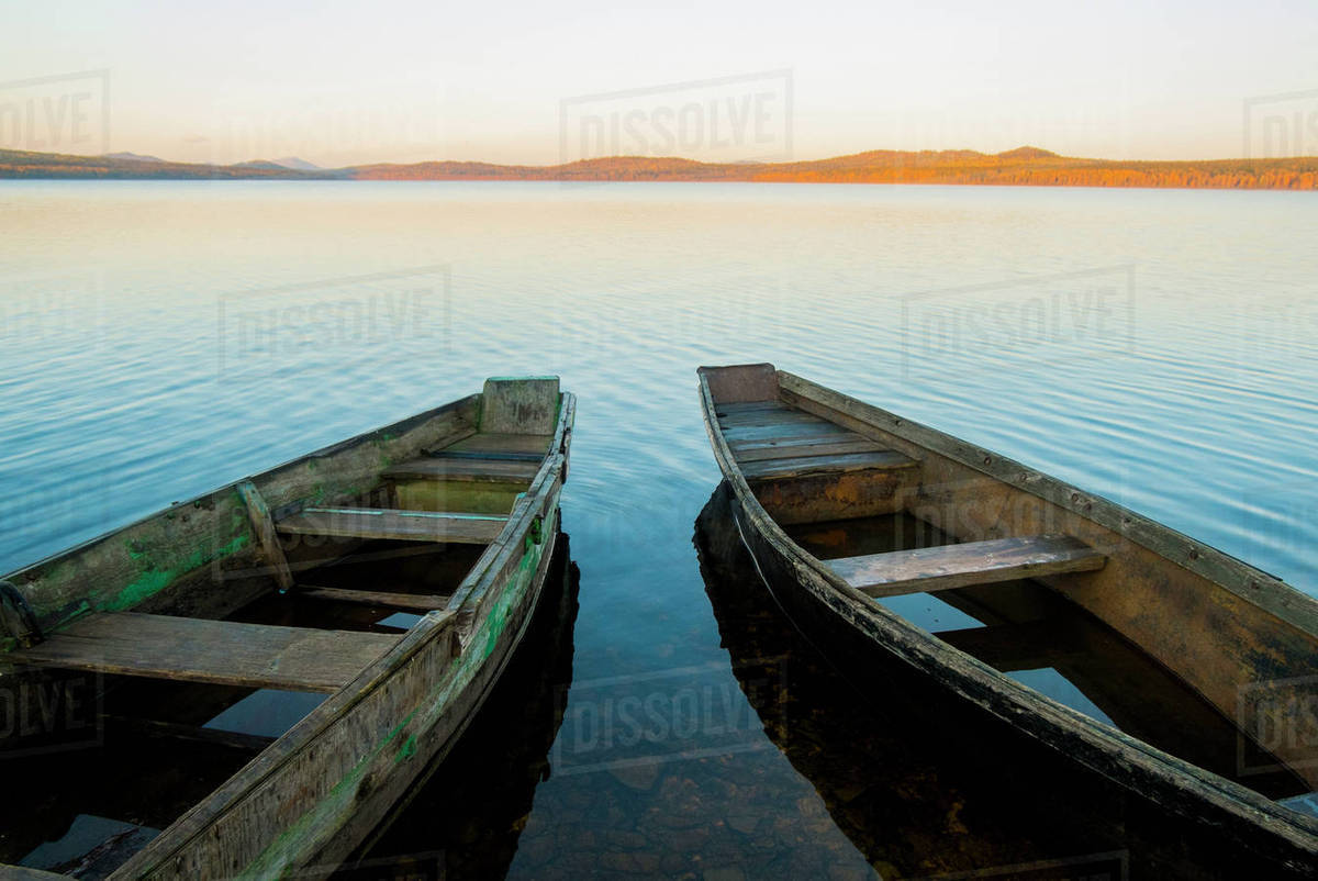 Two rowboats on lake at sunset - Royalty-free Stock Photo | Dissolve