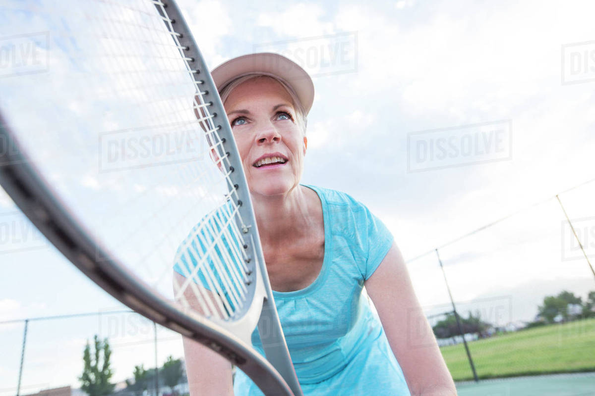 Caucasian woman holding tennis racket - Royalty-free Stock Photo | Dissolve