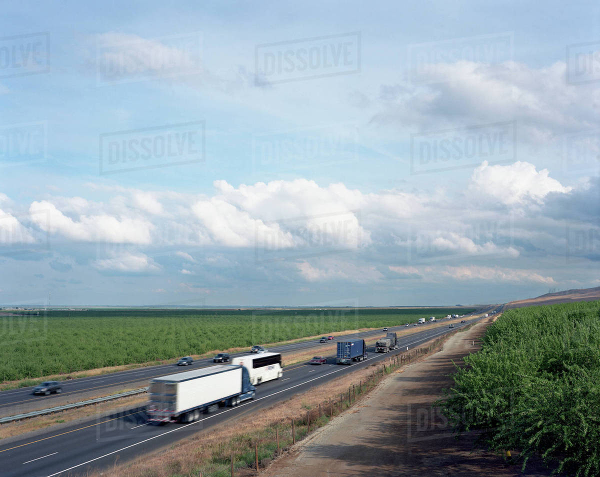 Trucks and cars driving on freeway - Royalty-free Stock Photo | Dissolve