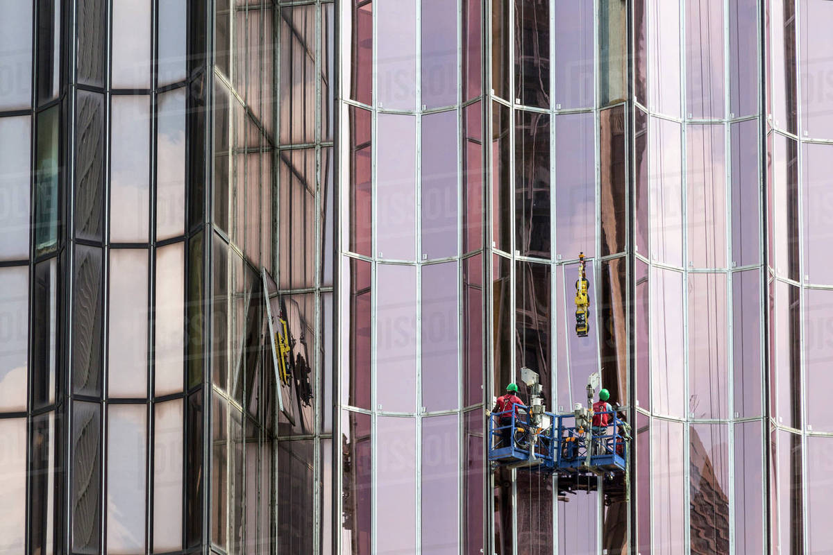 Men washing windows on skyscraper - Stock Photo - Dissolve
