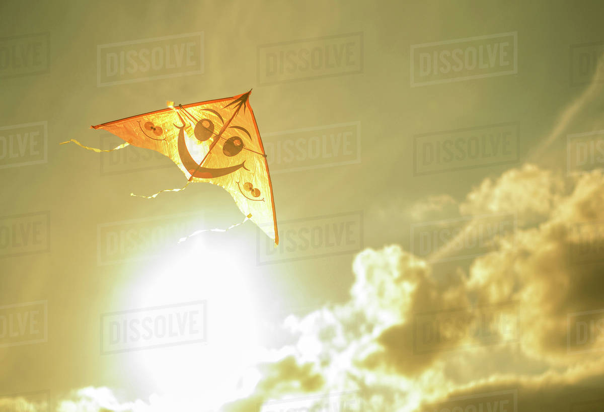 Kite flying in sunny sky - Stock Photo - Dissolve