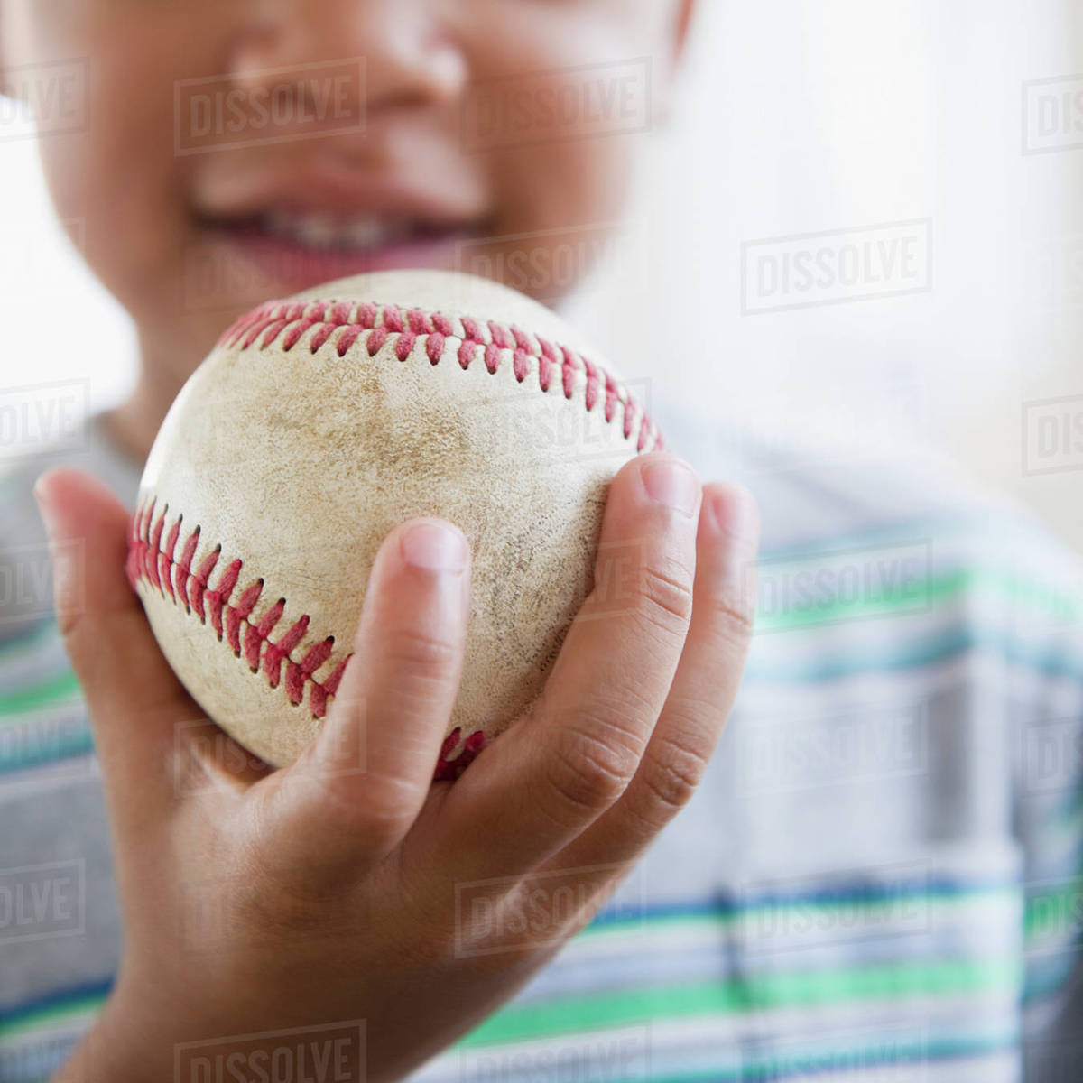 African American boy holding baseball - Royalty-free Stock Photo | Dissolve