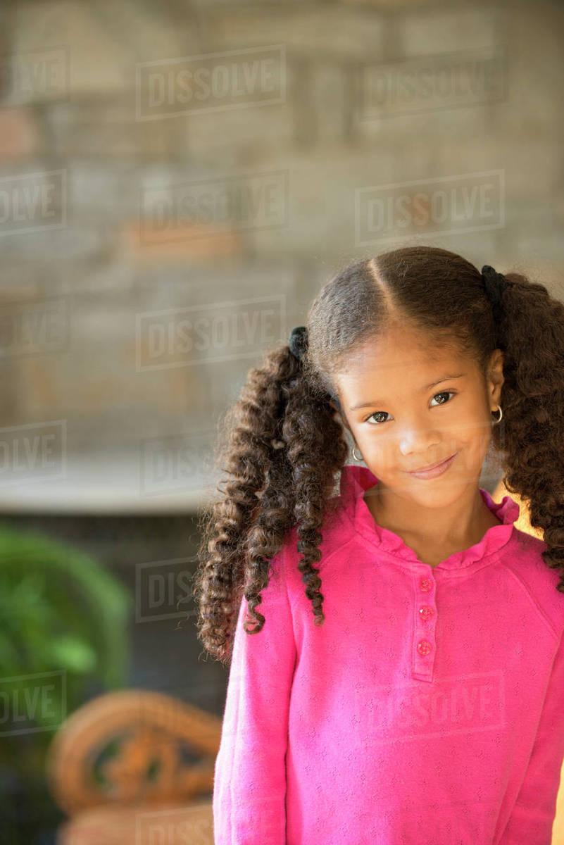 Portrait of smiling Mixed Race girl - Royalty-free Stock Photo | Dissolve