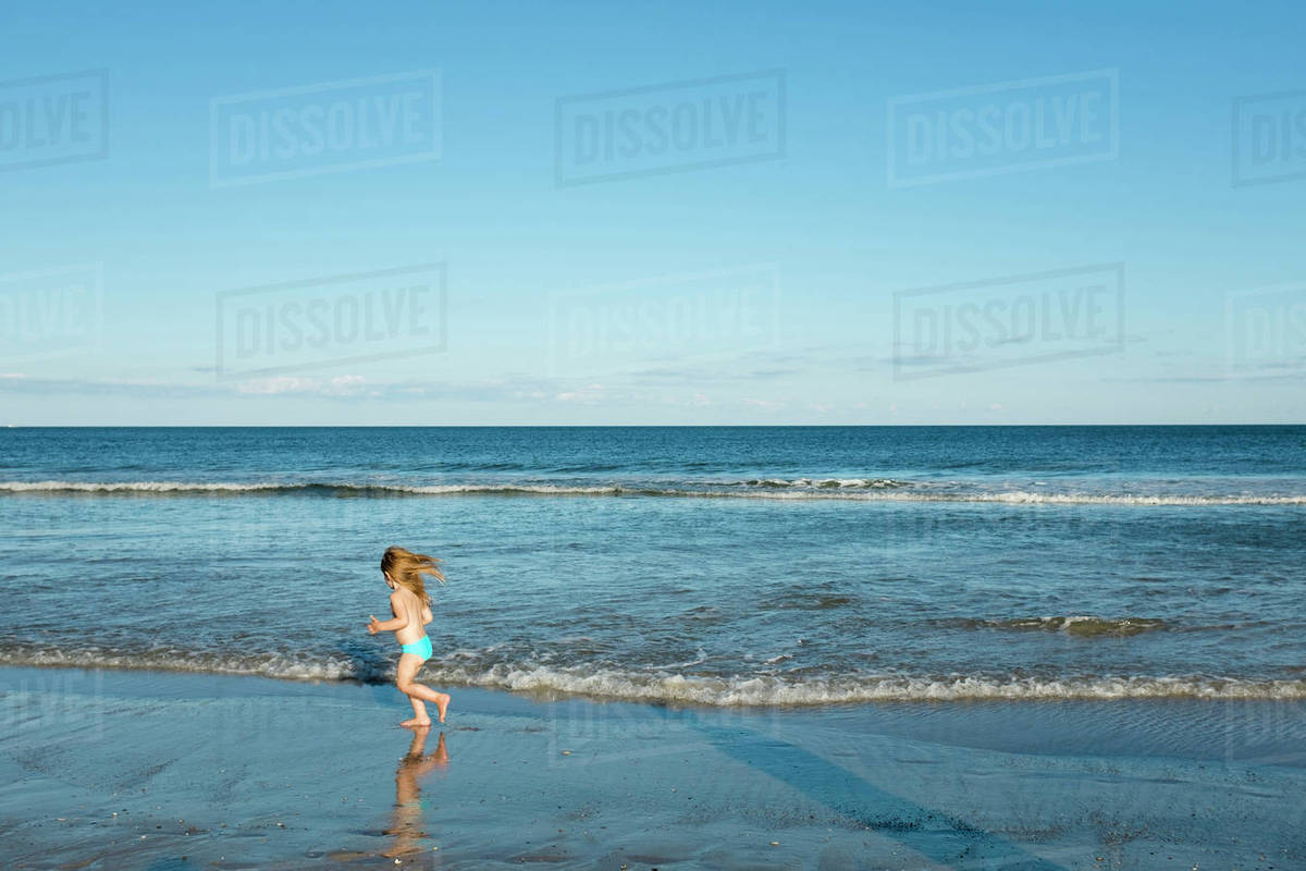 Girl running on beach - Stock Photo - Dissolve