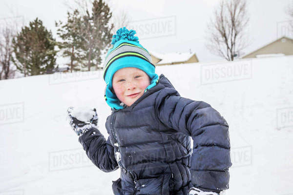 Smiling boy throwing snowball in winter - Royalty-free Stock Photo ...