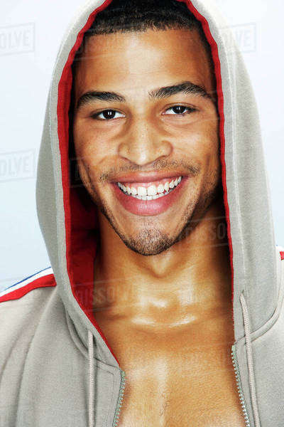 Mixed race man smiling in hoody - Royalty-free Stock Photo | Dissolve