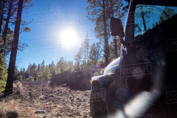 Car driving on dirt road on sunny day - Royalty-free Stock Photo | Dissolve