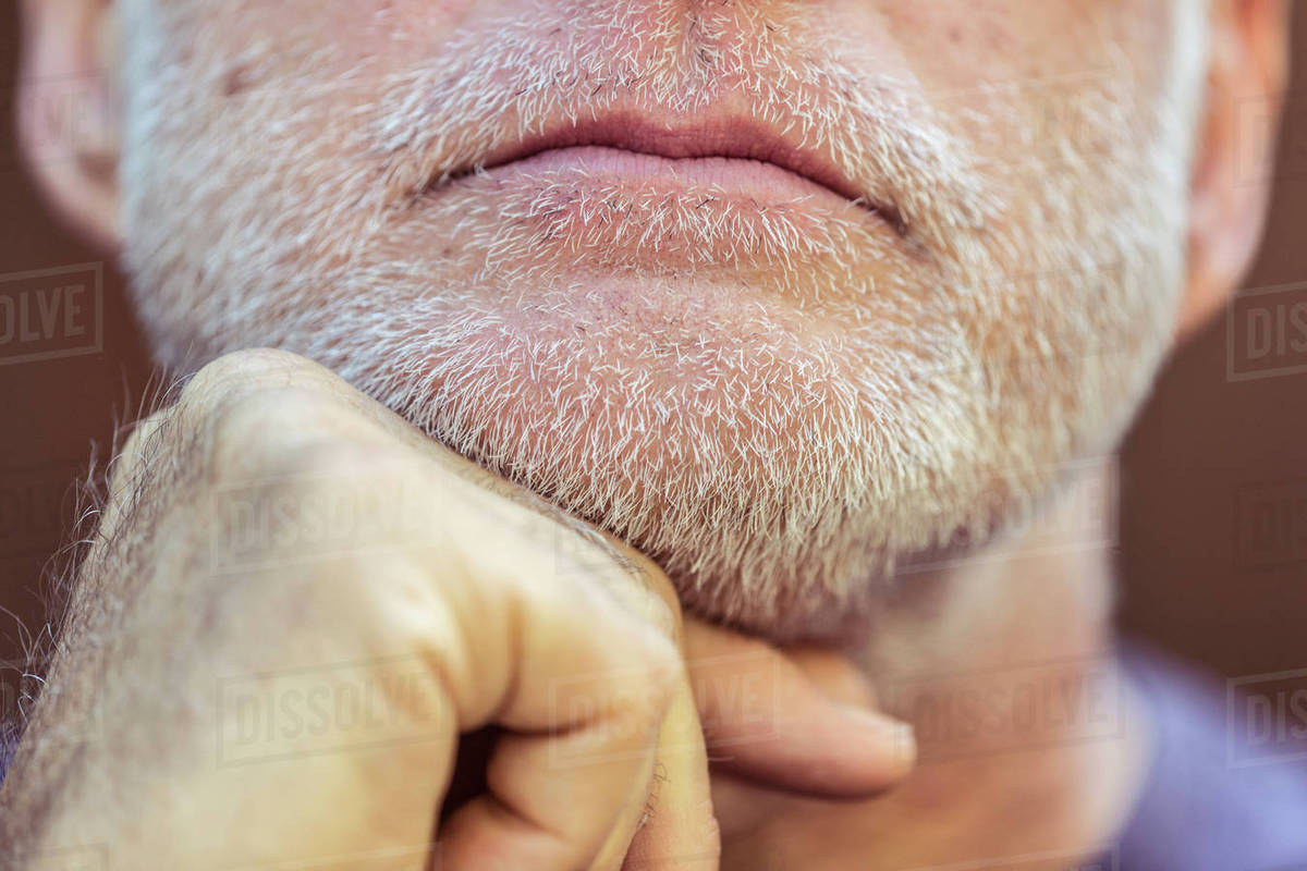 Close up of Caucasian man with hand on chin - Royalty-free Stock Photo ...