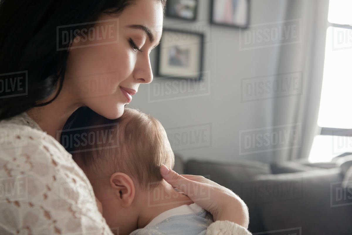 Caucasian mother comforting baby son - Stock Photo - Dissolve